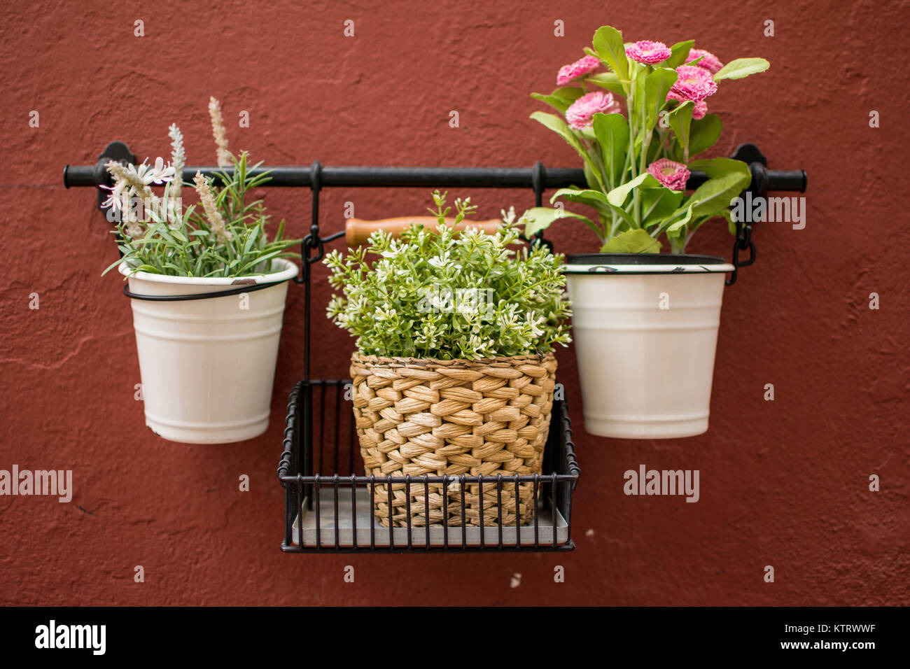 a trio of plant pots hanging on a wall in Marbella, Spain Stock Photo ...