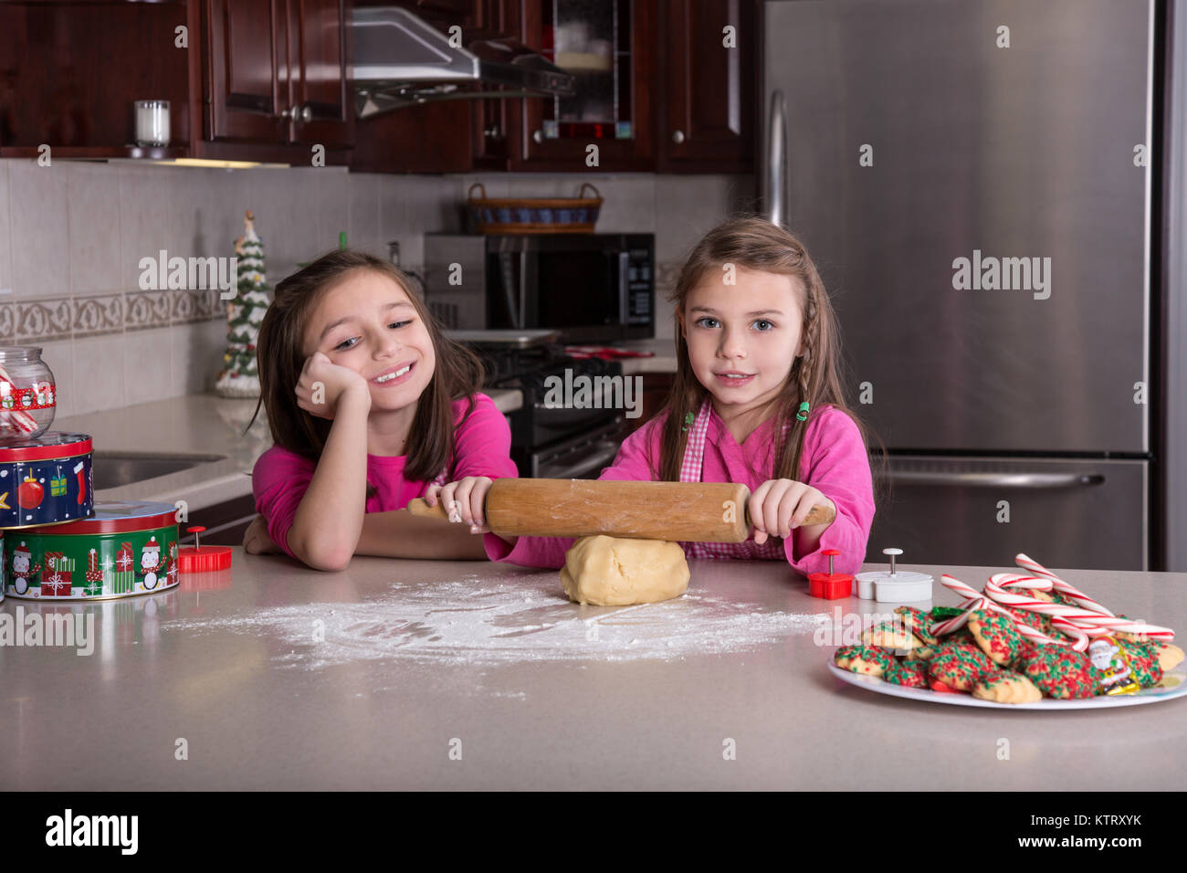 Young girls making Christmas cookies Stock Photo - Alamy