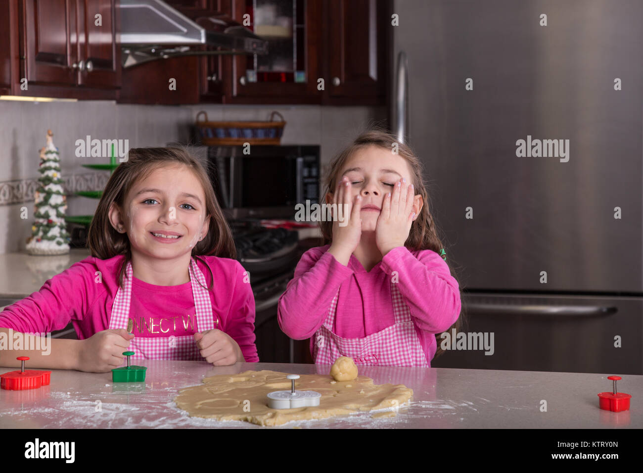 Young girls making Christmas cookies Stock Photo - Alamy