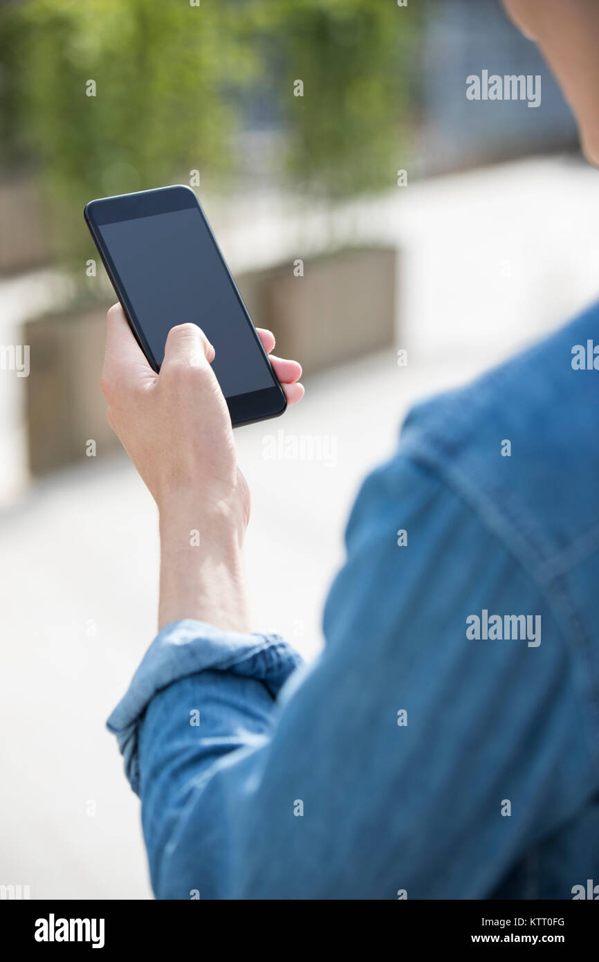 Young man using smart phone Stock Photo - Alamy
