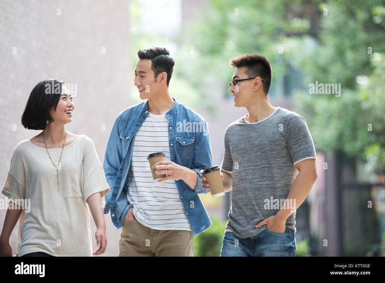 Cheerful young friends talking outdoors Stock Photo - Alamy