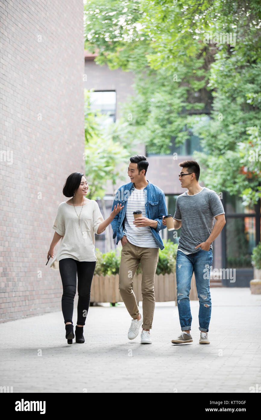 Cheerful young friends talking outdoors Stock Photo - Alamy