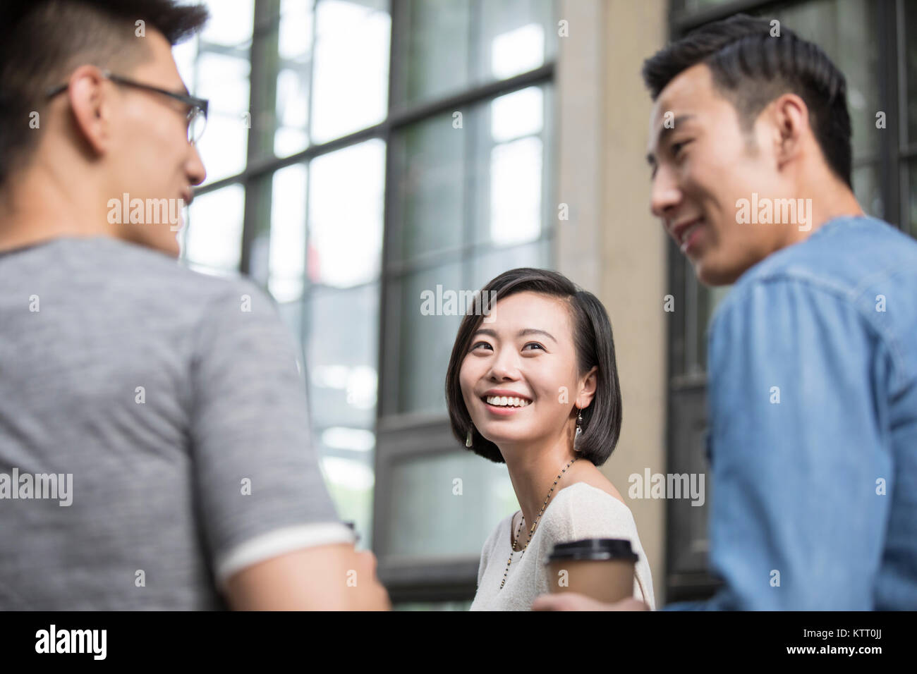 Cheerful young friends talking outdoors Stock Photo - Alamy