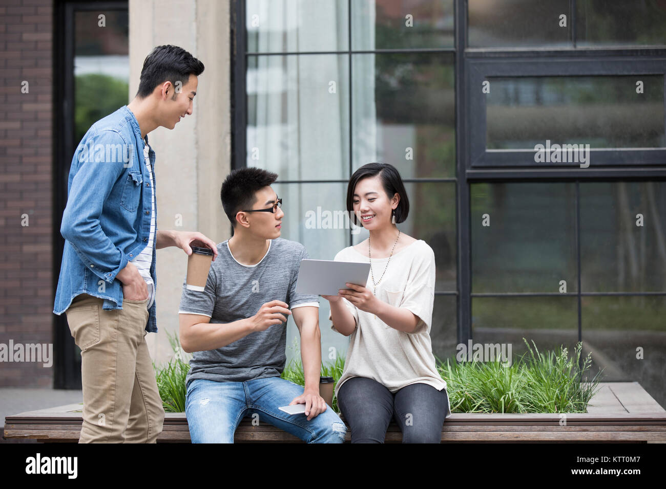 Confident designer team talking outdoors Stock Photo - Alamy