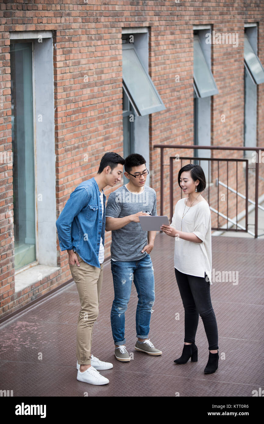 Confident designer team talking outdoors Stock Photo - Alamy