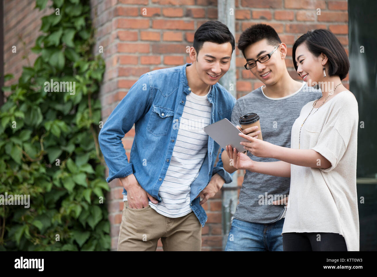 Confident designer team talking outdoors Stock Photo - Alamy