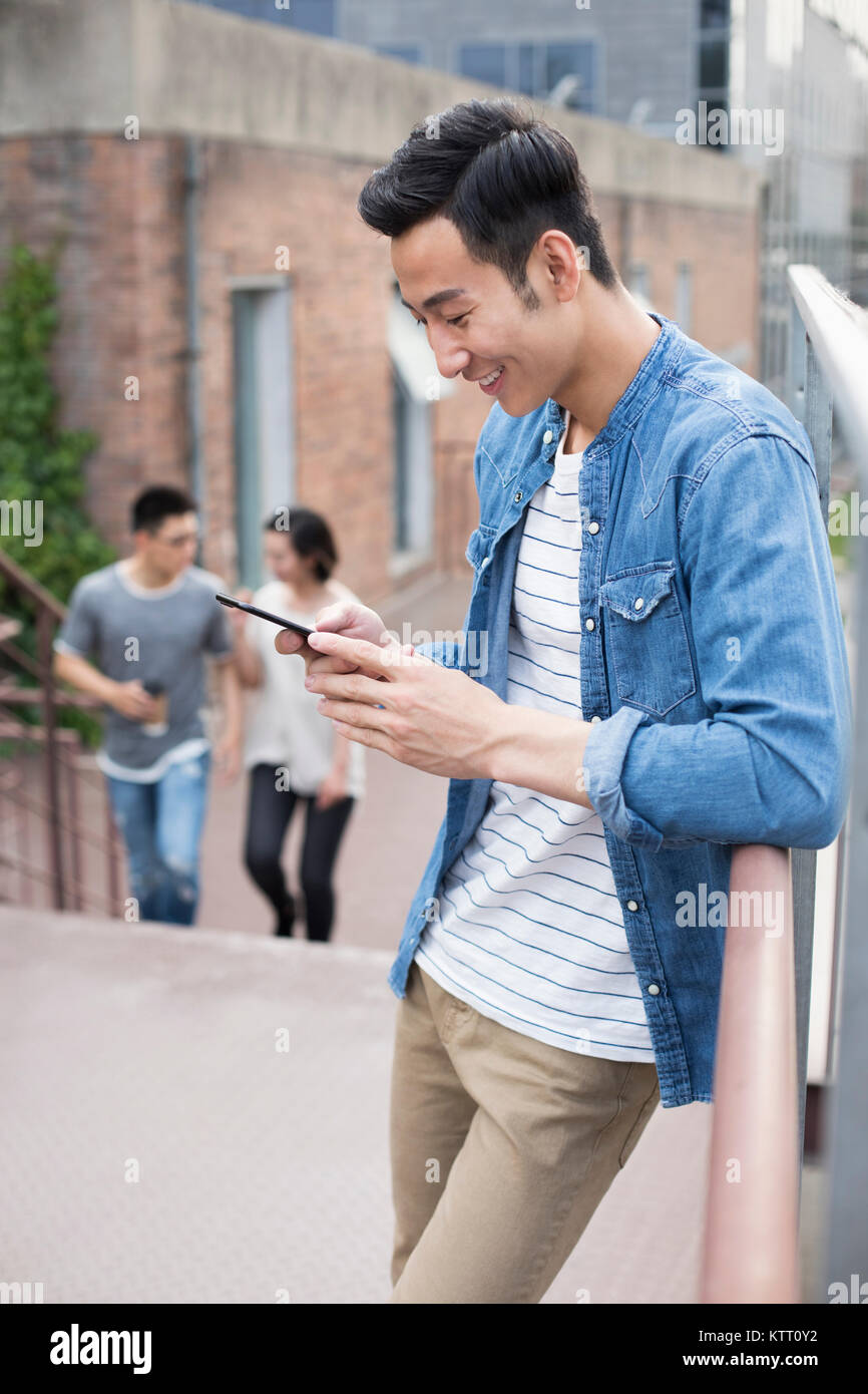 Young man using smart phone Stock Photo - Alamy
