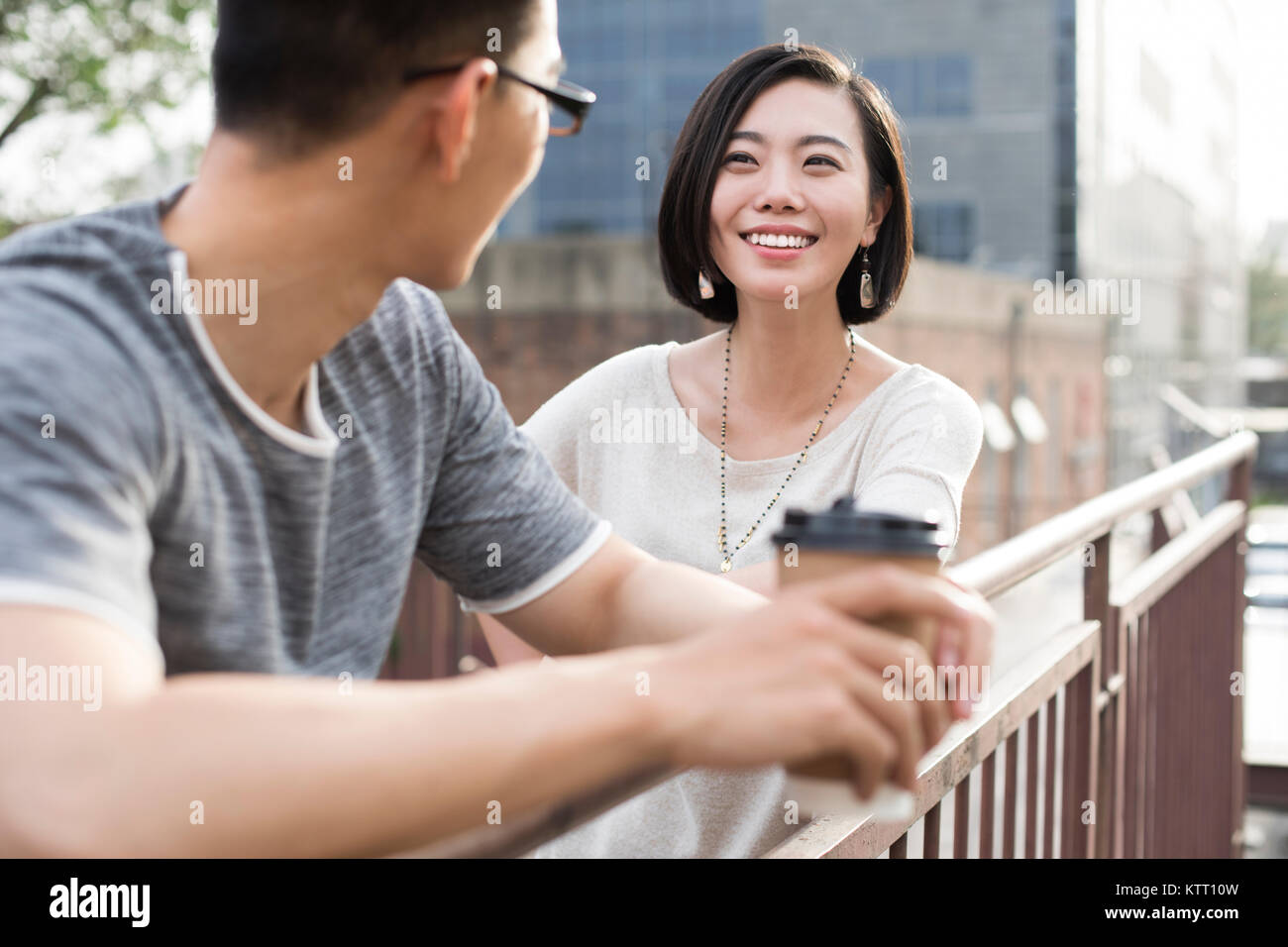 Cheerful young couple talking outdoors Stock Photo - Alamy