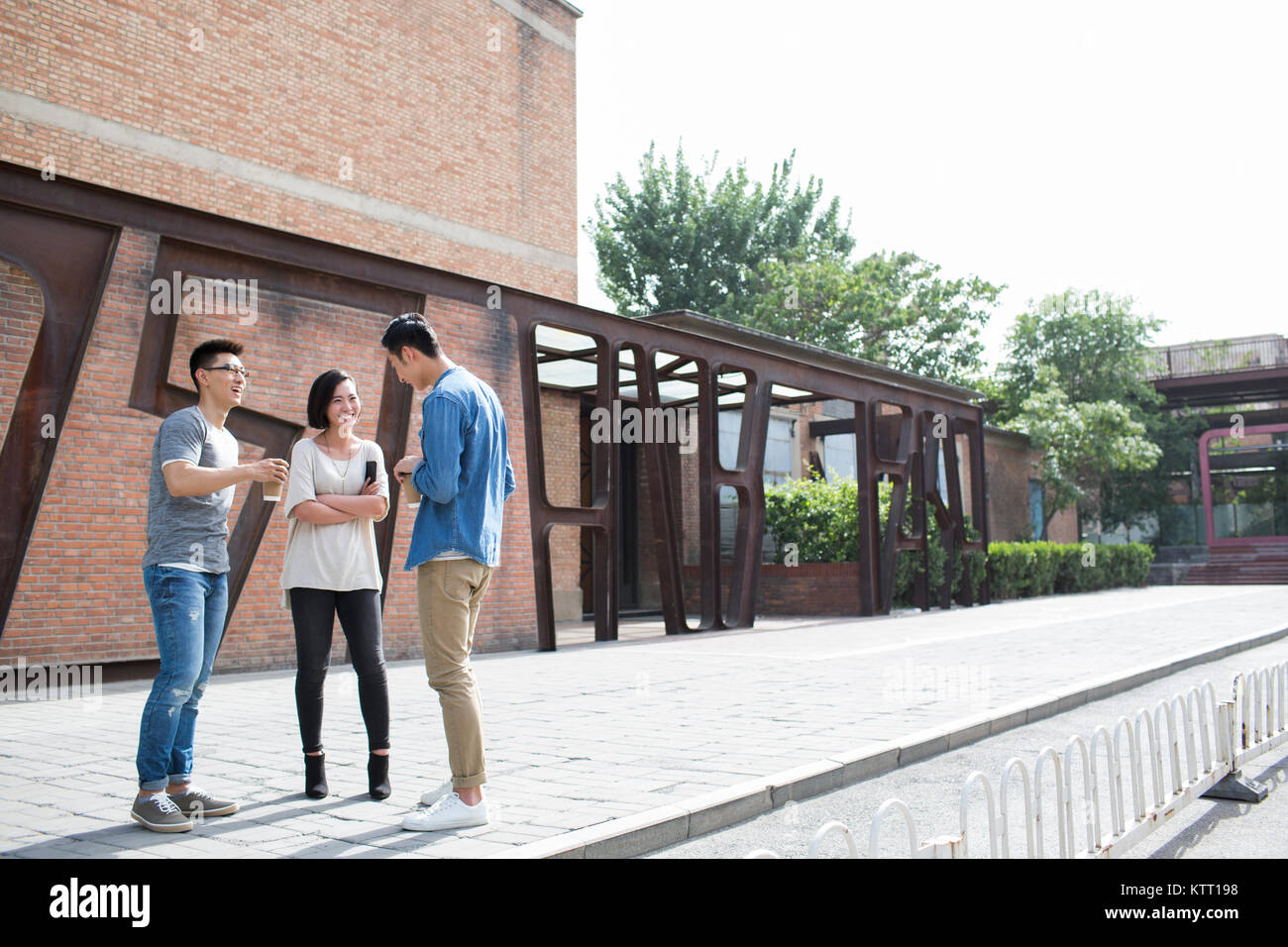 Cheerful young friends talking outdoors Stock Photo - Alamy