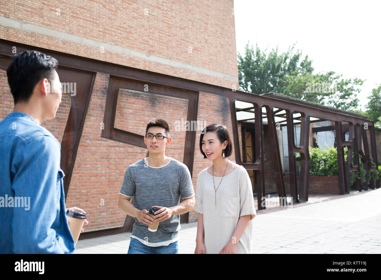 Cheerful young friends talking outdoors Stock Photo - Alamy