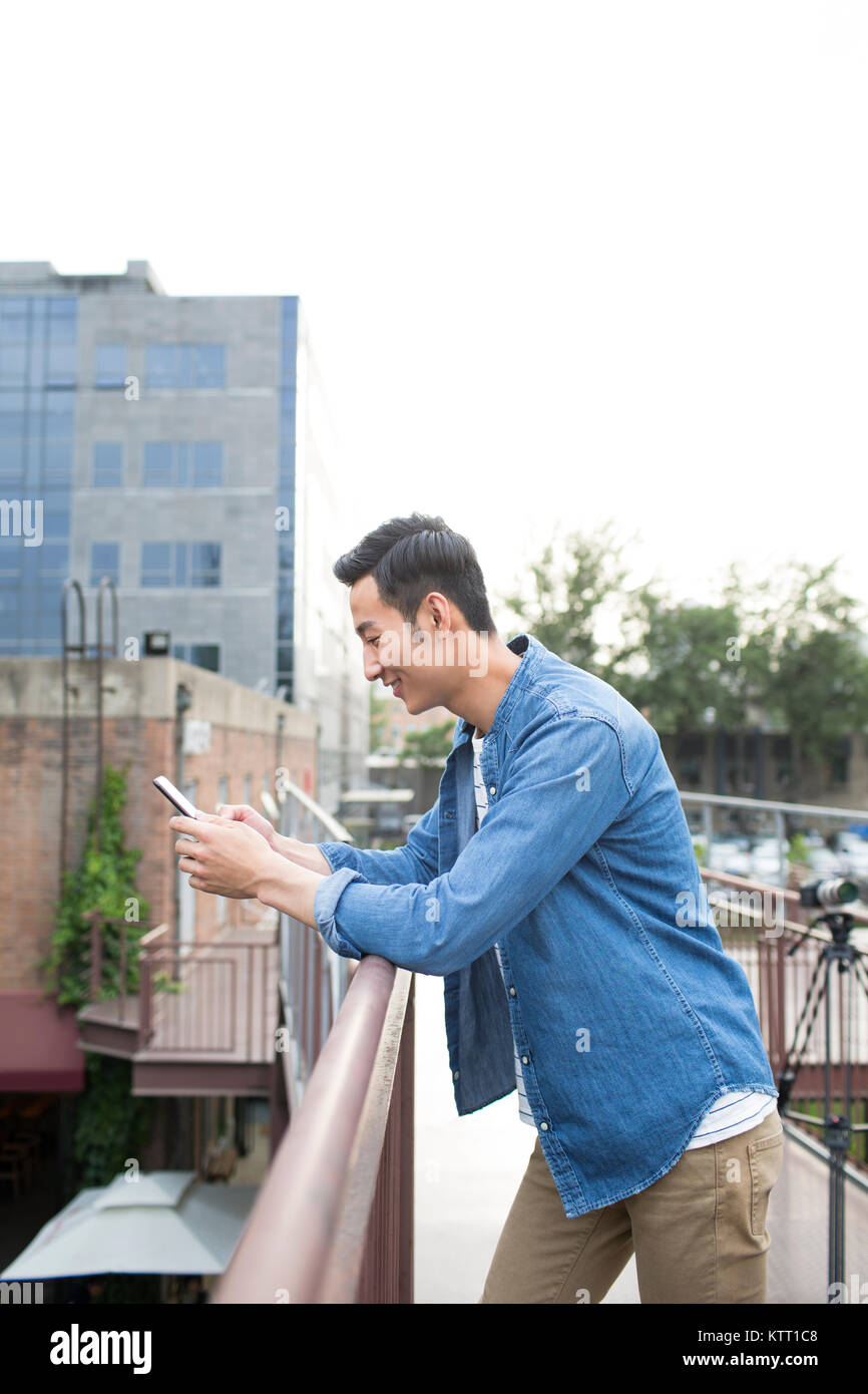 Young man using smart phone Stock Photo - Alamy