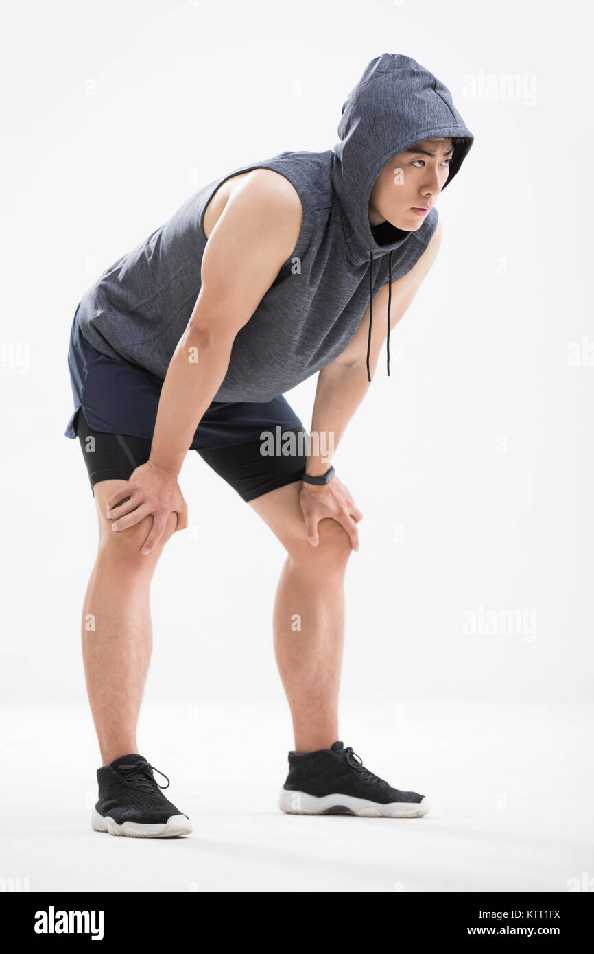 Young man resting after running Stock Photo - Alamy