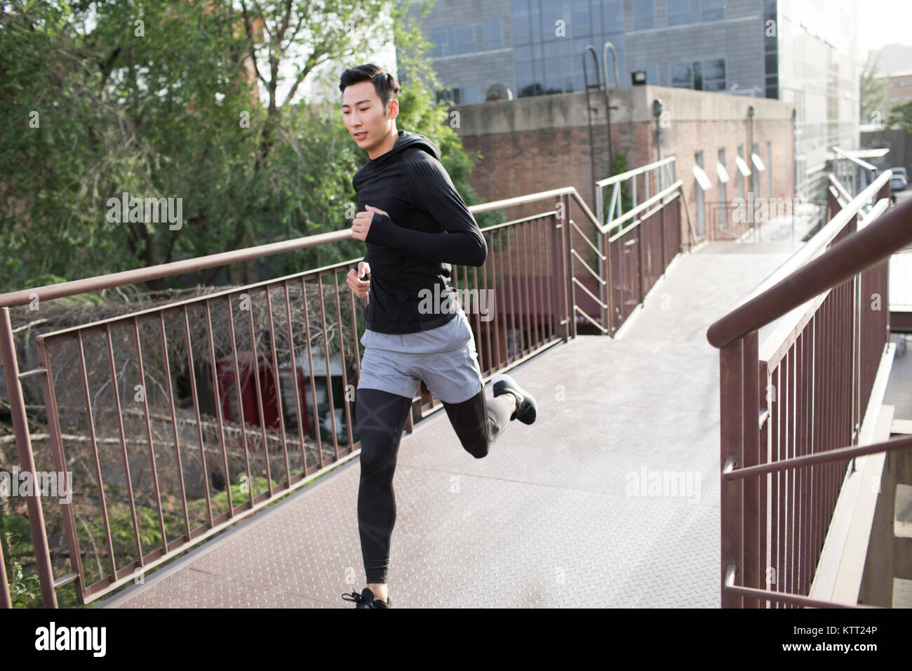 Young man jogging outdoors Stock Photo - Alamy