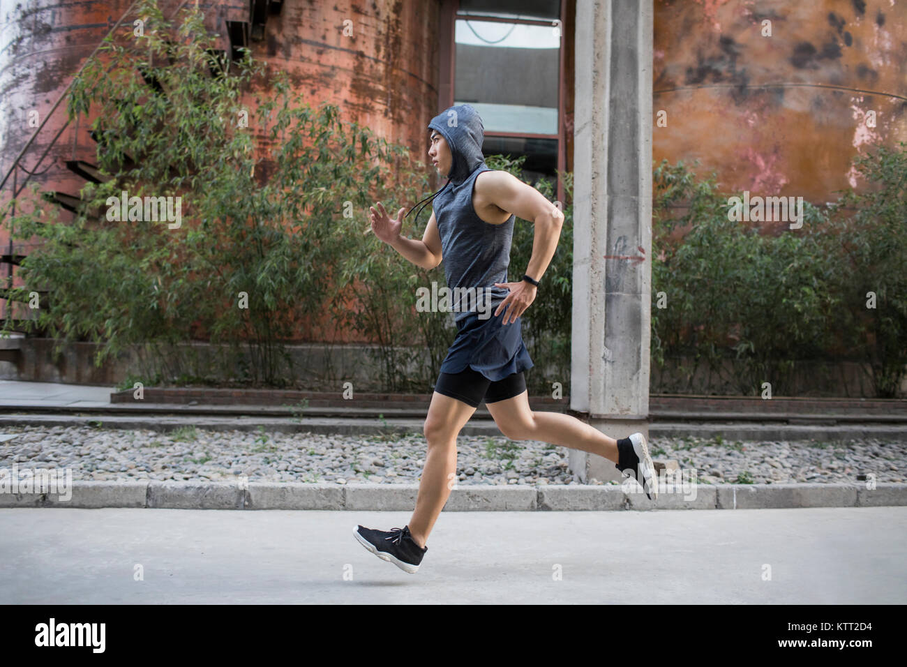 Young man jogging outdoors Stock Photo - Alamy