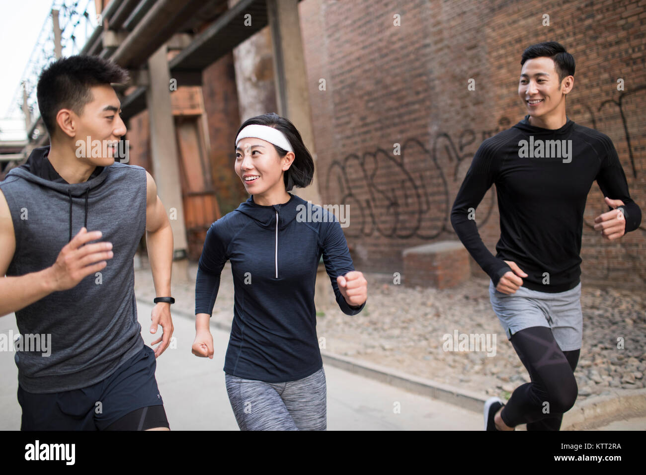 Young friends jogging outdoors Stock Photo - Alamy