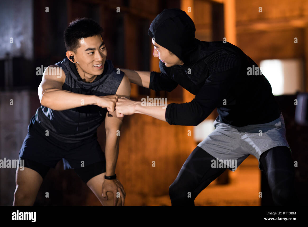 Young friends fist bumping Stock Photo - Alamy