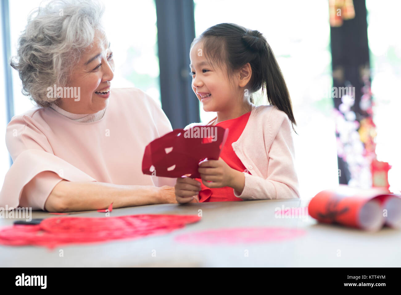 Granddaughter and grandmother with Chinese New Year paper-cut Stock ...