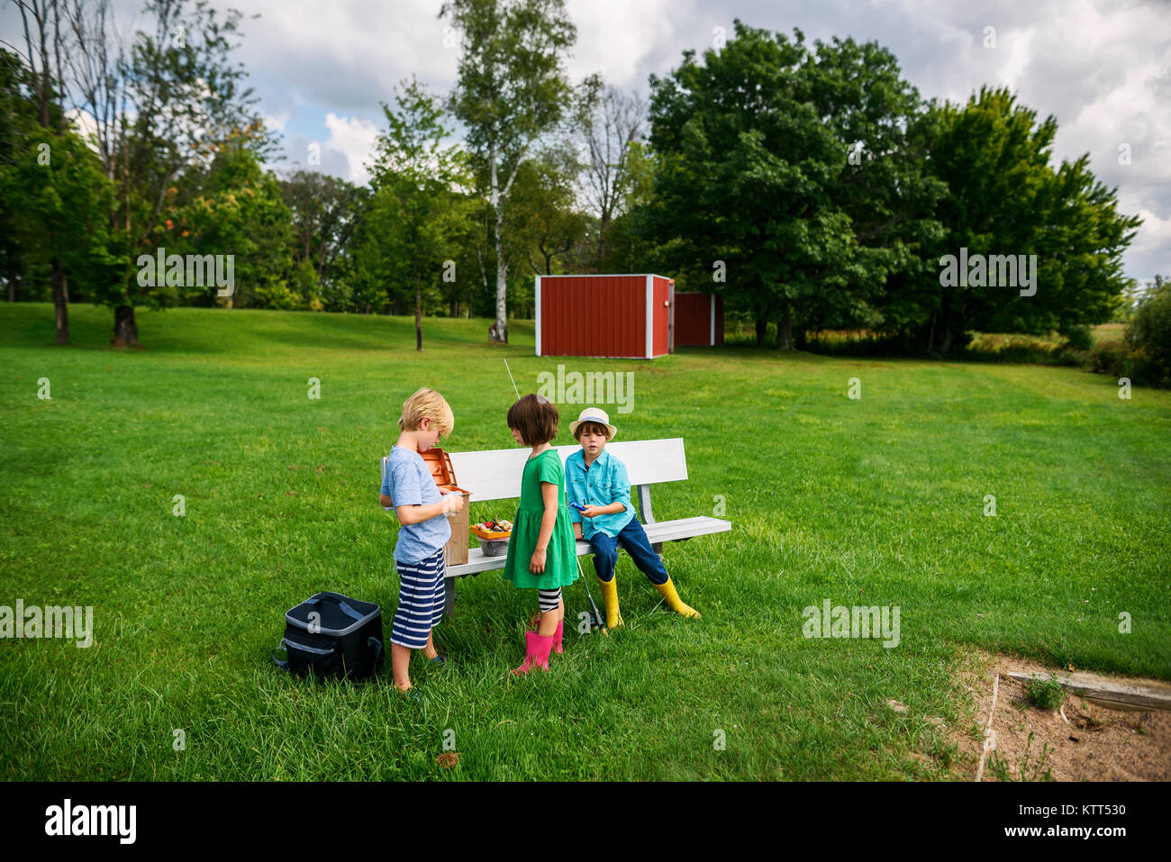 Three children in the park getting ready to go fishing Stock Photo - Alamy