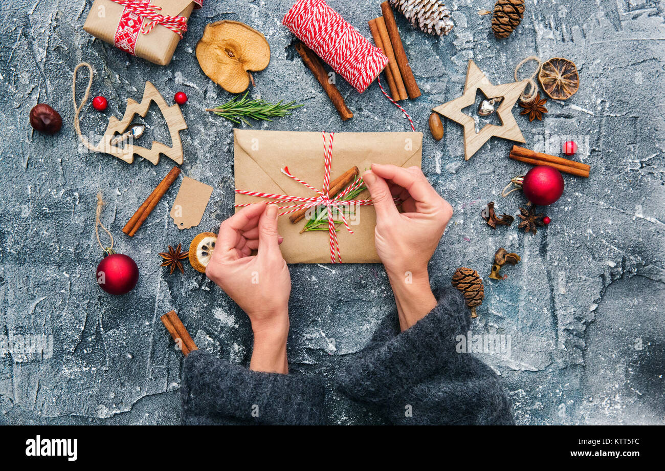 Woman's hands wrapping a Christmas gift Stock Photo - Alamy