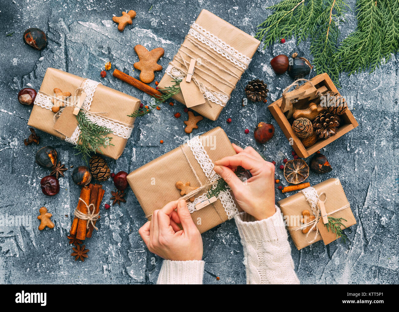 Woman's hands wrapping Christmas gifts Stock Photo - Alamy