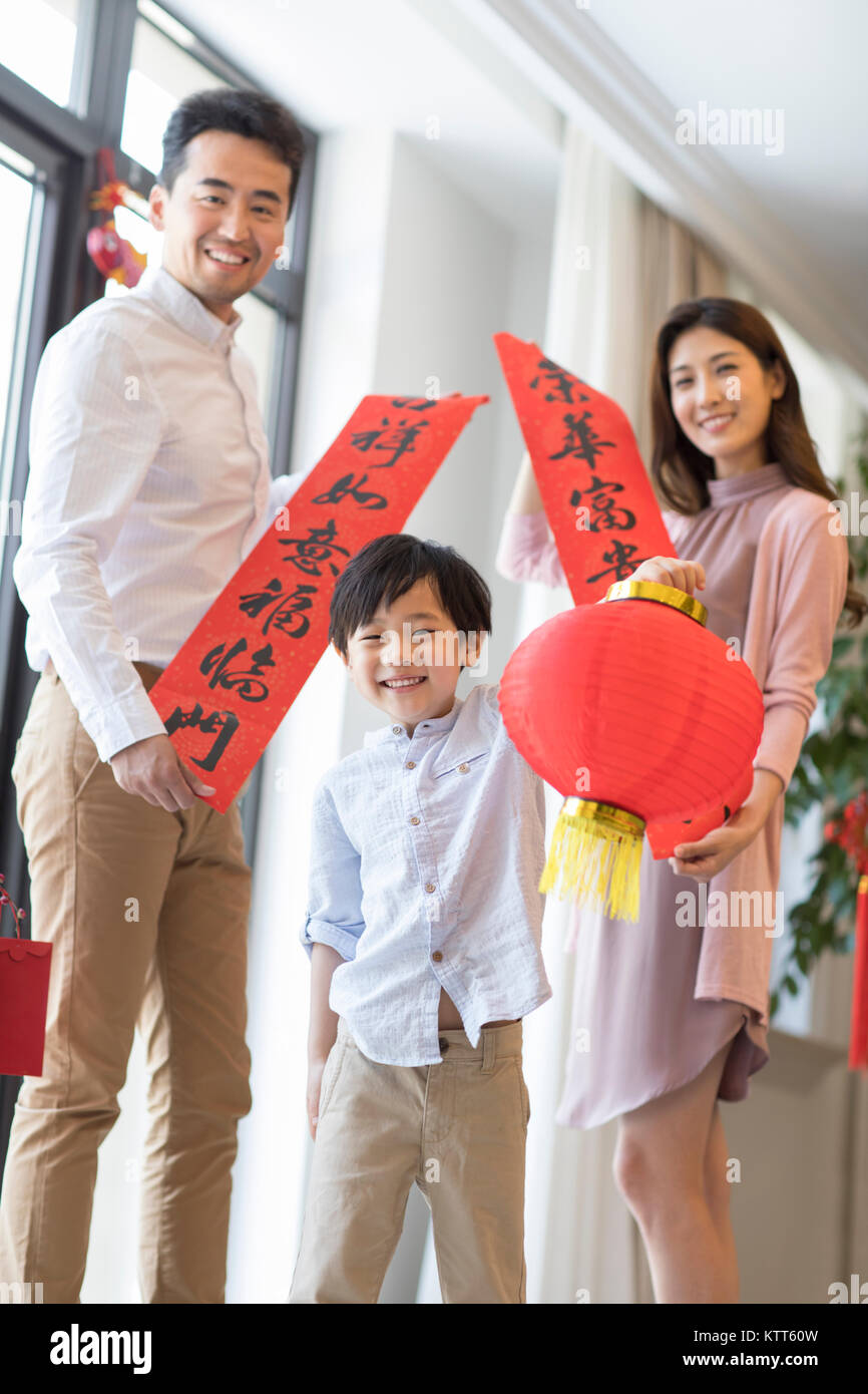 Cheerful young family celebrating Chinese New Year Stock Photo - Alamy