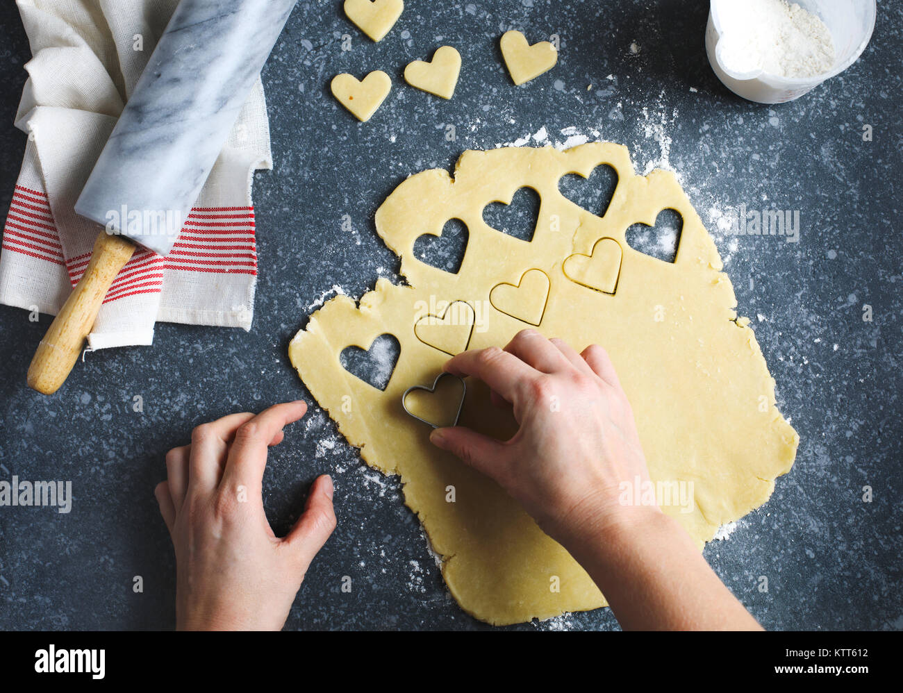Woman baking heart shaped cookies Stock Photo - Alamy