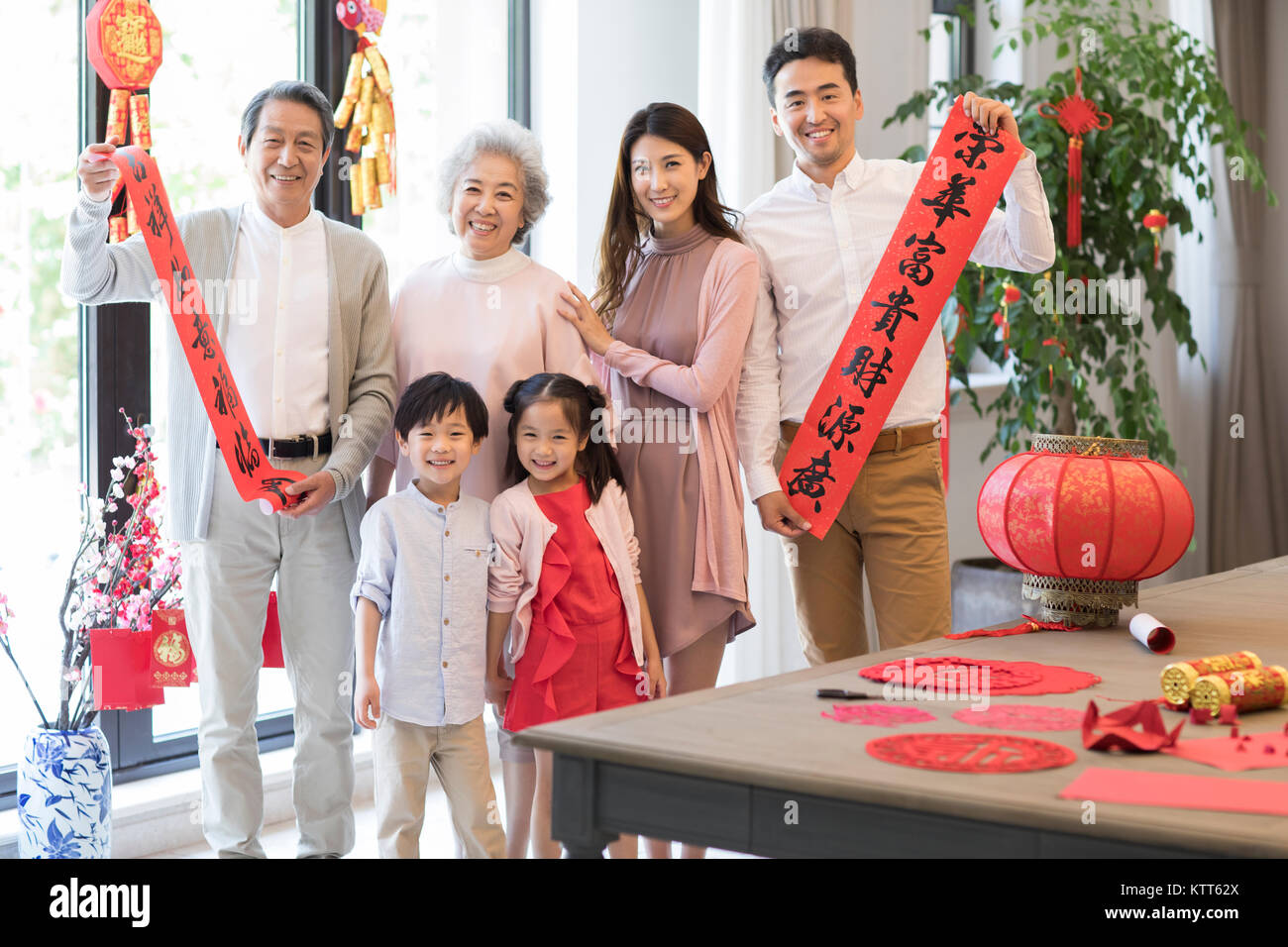 Cheerful young family celebrating Chinese New Year Stock Photo - Alamy