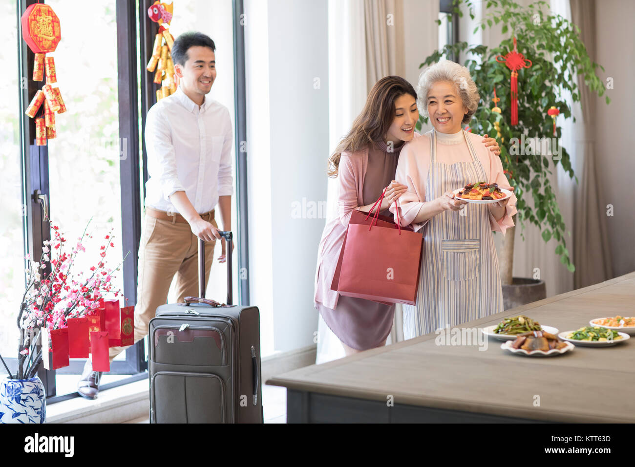 Young couple visiting their mother during Chinese new year Stock Photo ...