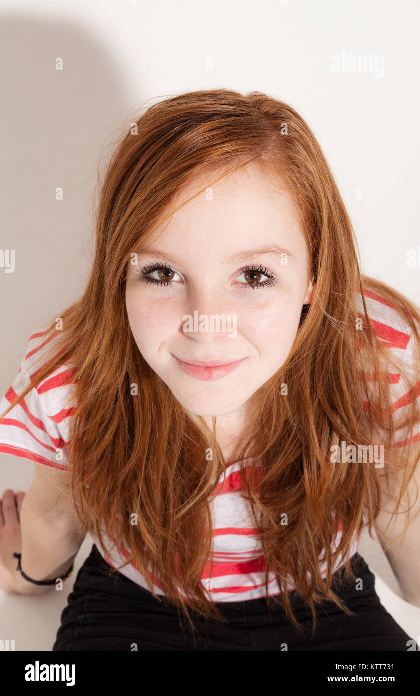 portrait of cute redheaded girl, background wall Stock Photo - Alamy