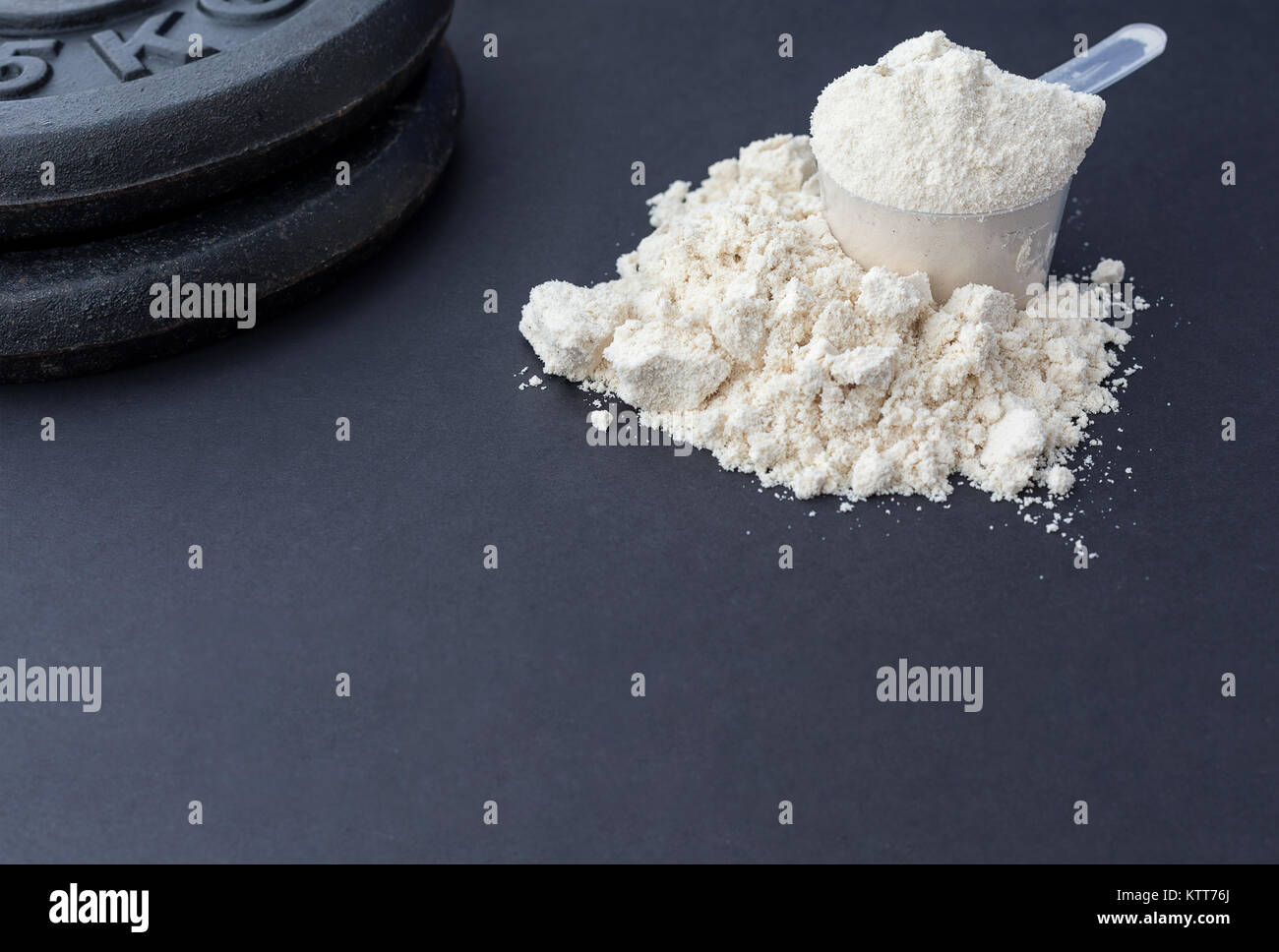 Protein Powder on dark with weights plates Stock Photo - Alamy