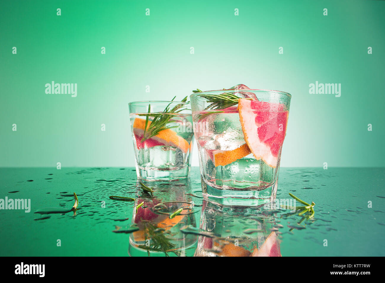 The closeup of a cape cod cocktail or vodka with fruits on blue studio ...