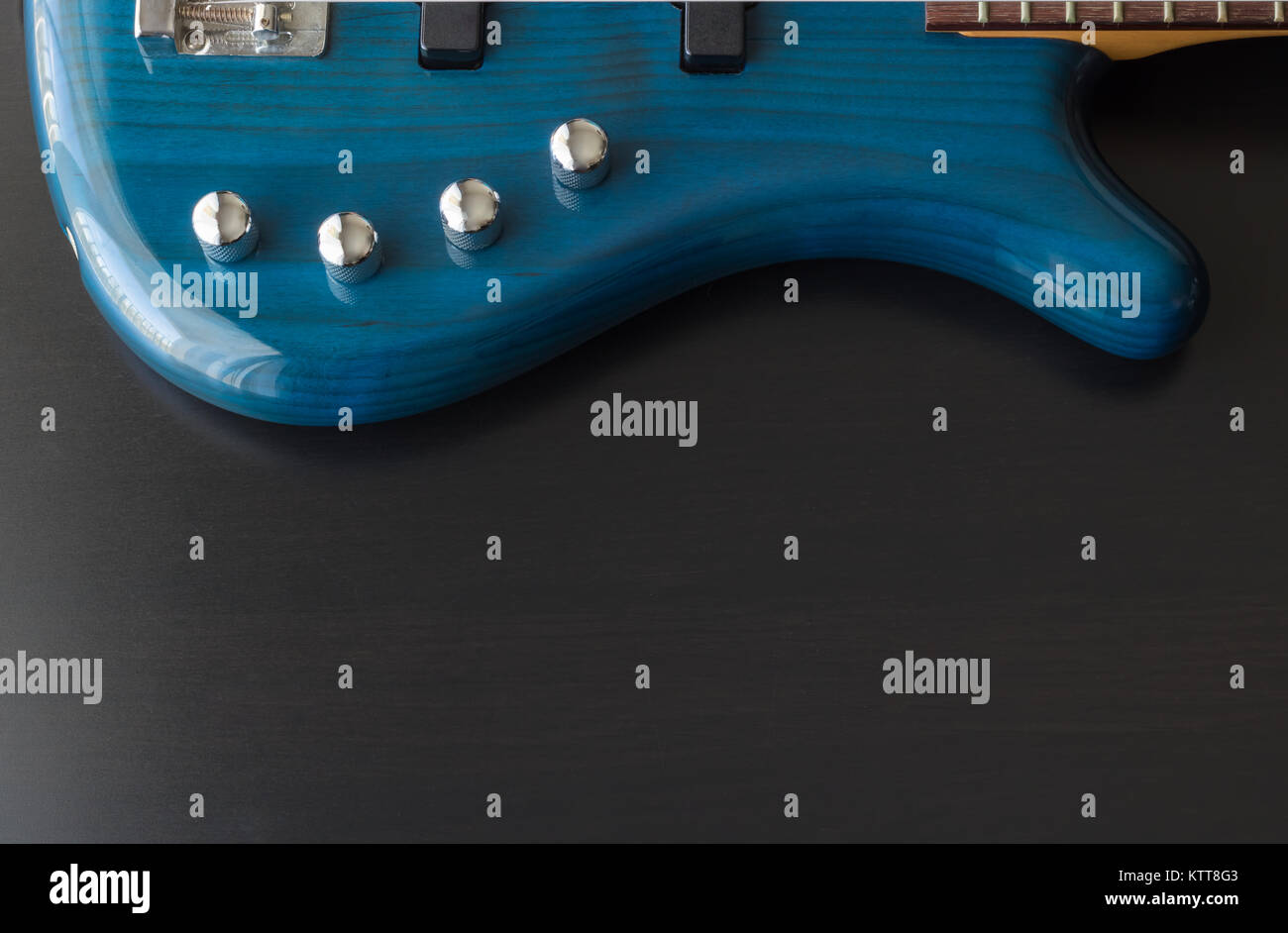 A blue five string bass guitar is strategically positioned in the frame ...