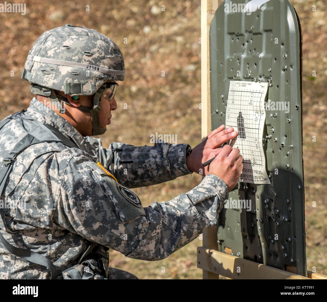 U.S. Army Staff Sgt. Marcus Jones checks his M4's zero before shooting ...