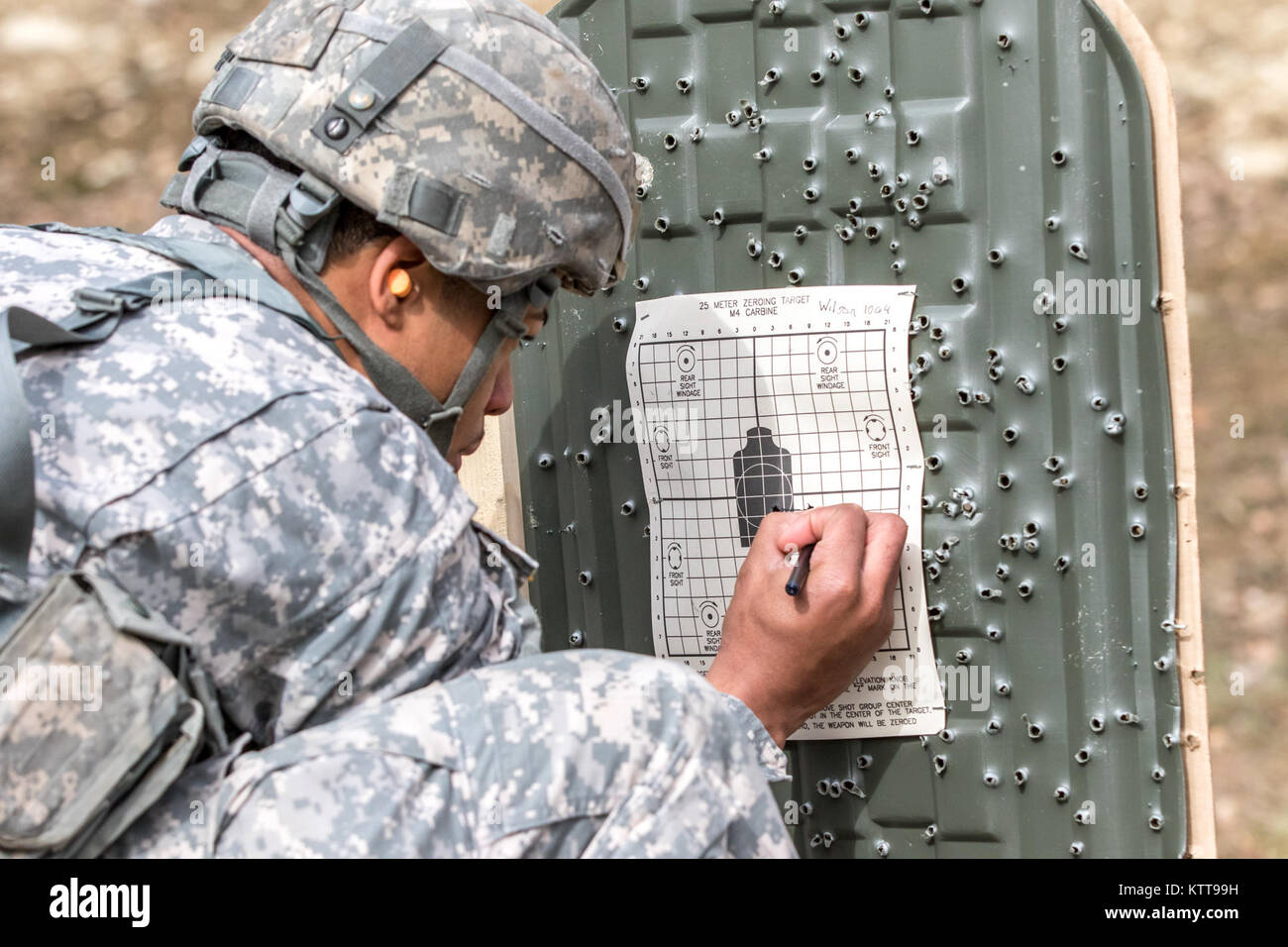 U.S. Army Sgt. James Wilson checks his M4's zero before shooting a ...