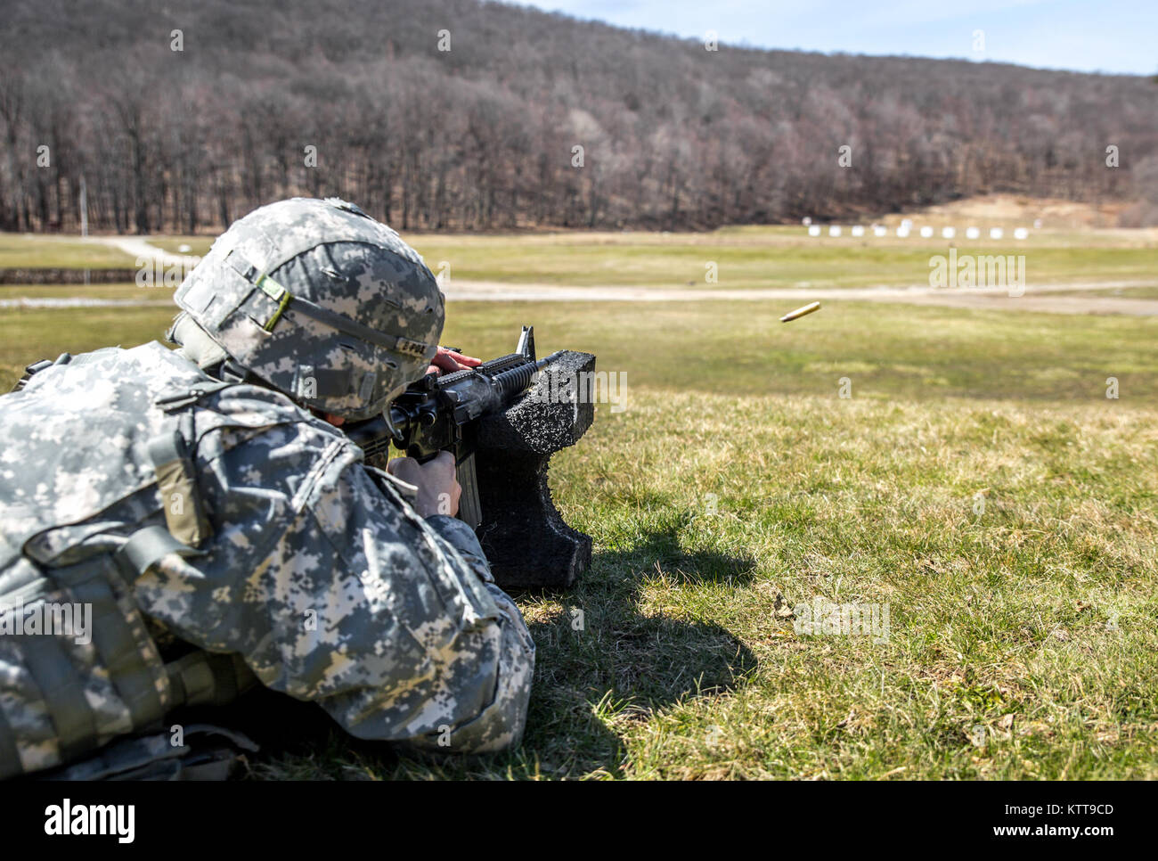 A Soldier runs through the stress shoot lane combining physical tests ...