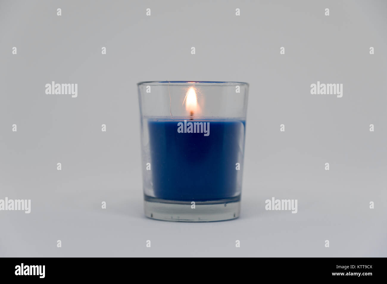 A wax candle in a glass container Stock Photo - Alamy