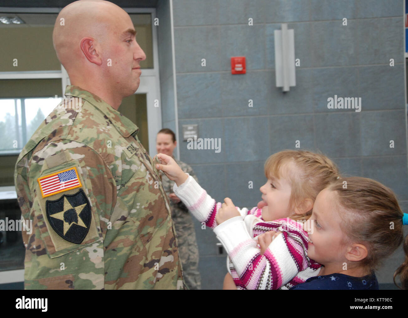 Maya Starr holds up her little sister Gwyn as they put new rank on ...