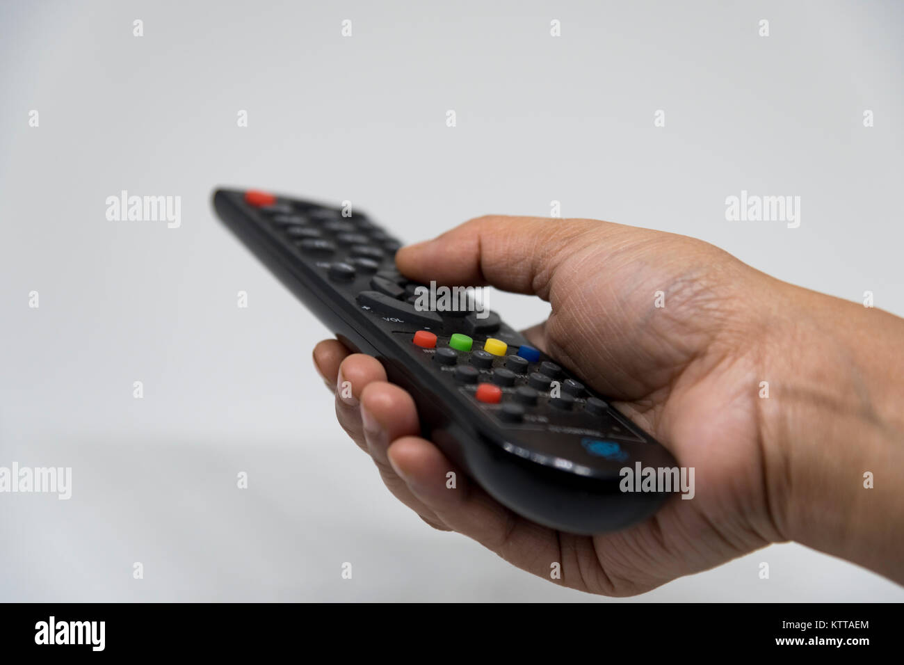 A hand holding TV remote Stock Photo - Alamy