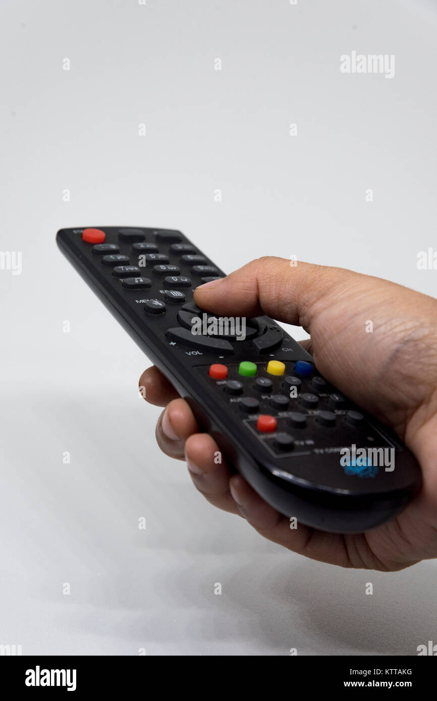 A hand holding TV remote Stock Photo - Alamy