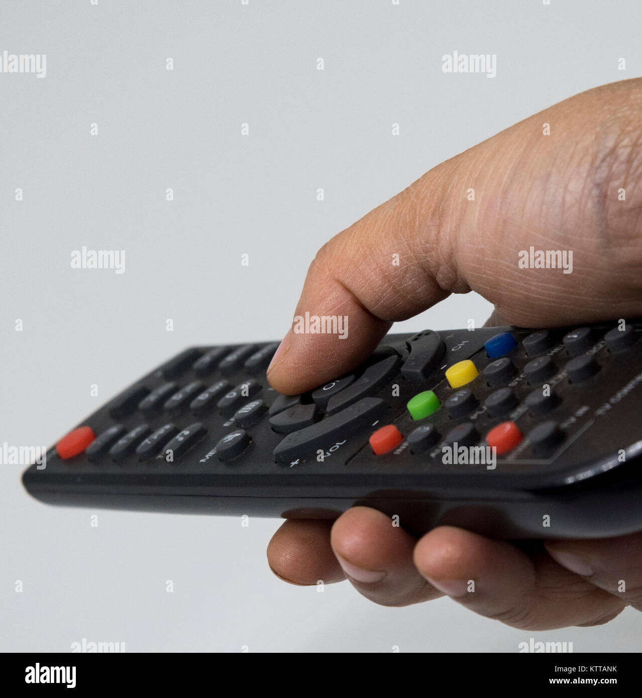 A hand holding TV remote Stock Photo - Alamy