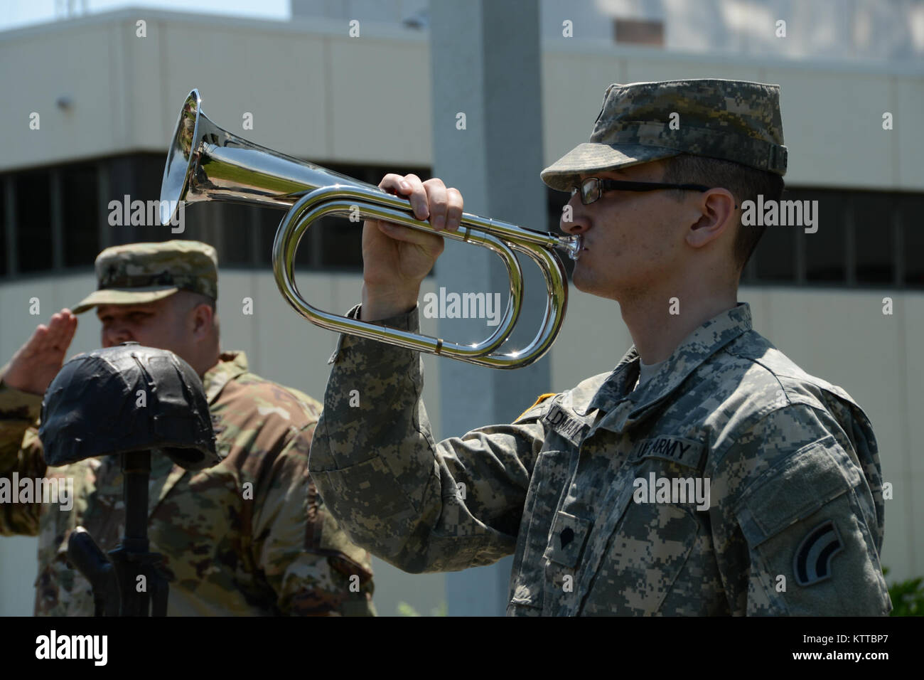 A N.Y. Army National Guard Soldier plays Taps at a memorial service at ...