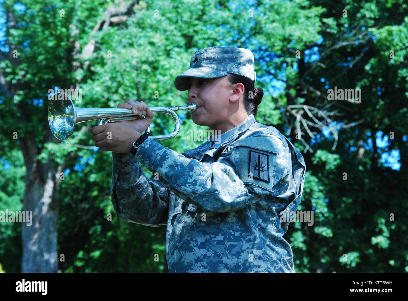 New York Army National Guard Cpl. Taylor Kuchera plays taps to render ...