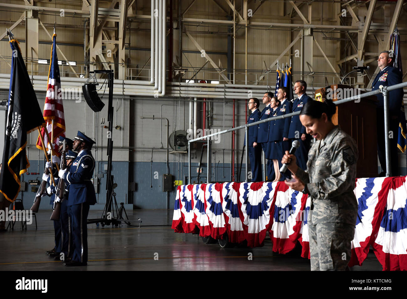 The official party stands at attention as “The Star-Spangled Banner” is ...