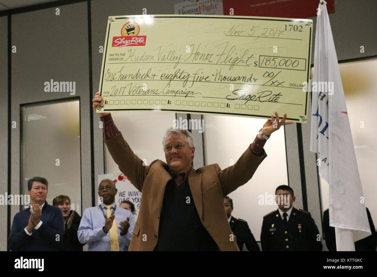Shoprite President Brett Wing displays a donation November 4, 2017 ...
