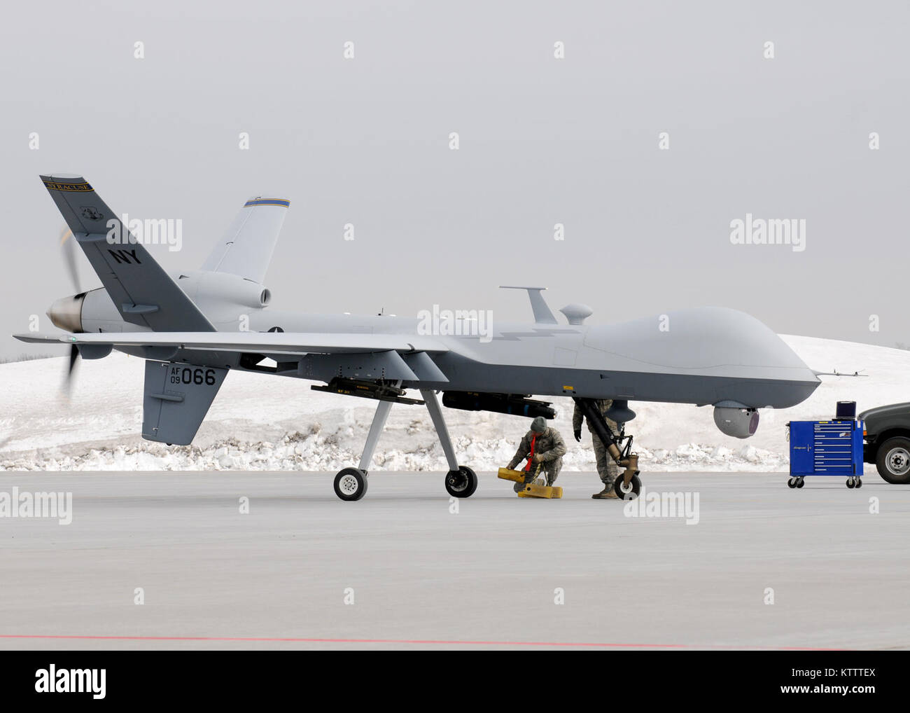 Members of the 174th Fighter Wing place chalks on an MQ-9 returning ...