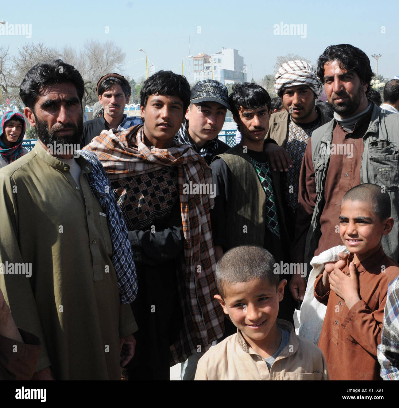 A group of Afghan men and boys gather outside the Blue Mosque in Mazar ...