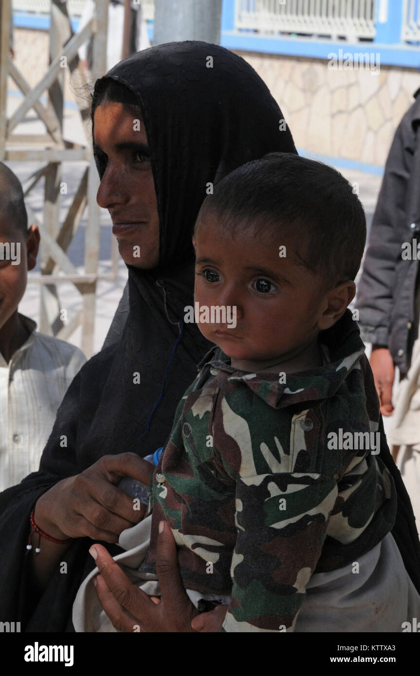 An Afghan woman holds her son in Mazar-e-Sharif, Bahlk Province ...