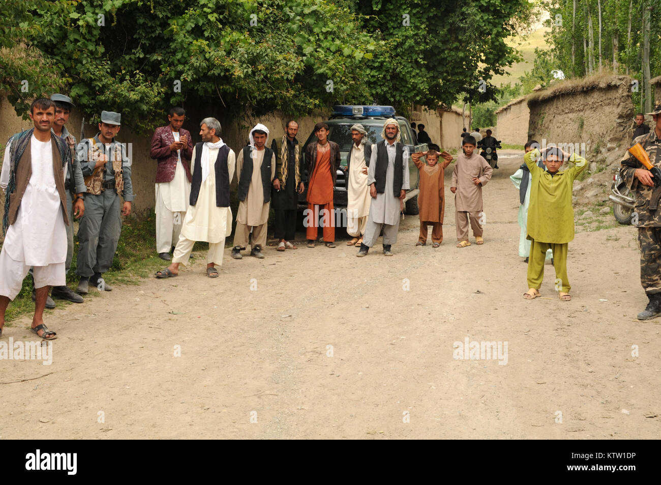 Afghan villagers gather in the street in Khwahan, Badakhshan Province ...