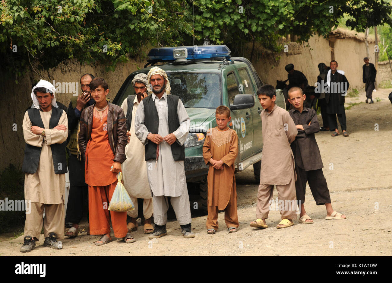 Afghan villagers gather in the street in Khwahan, Badakhshan Province ...
