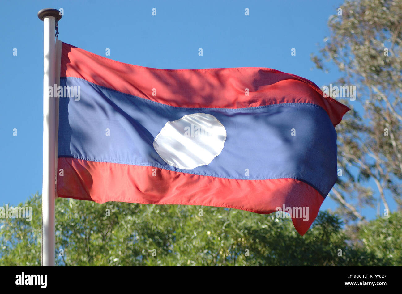 the flag of Laos against blue sky Stock Photo - Alamy